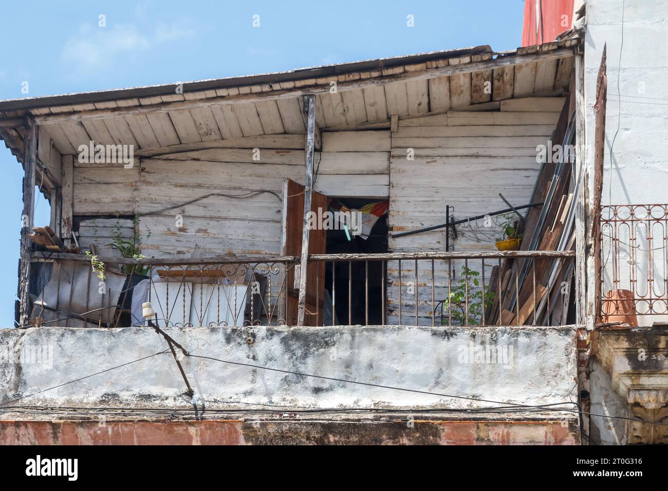 A wooden walls house on a second floor of a building. The run down ...