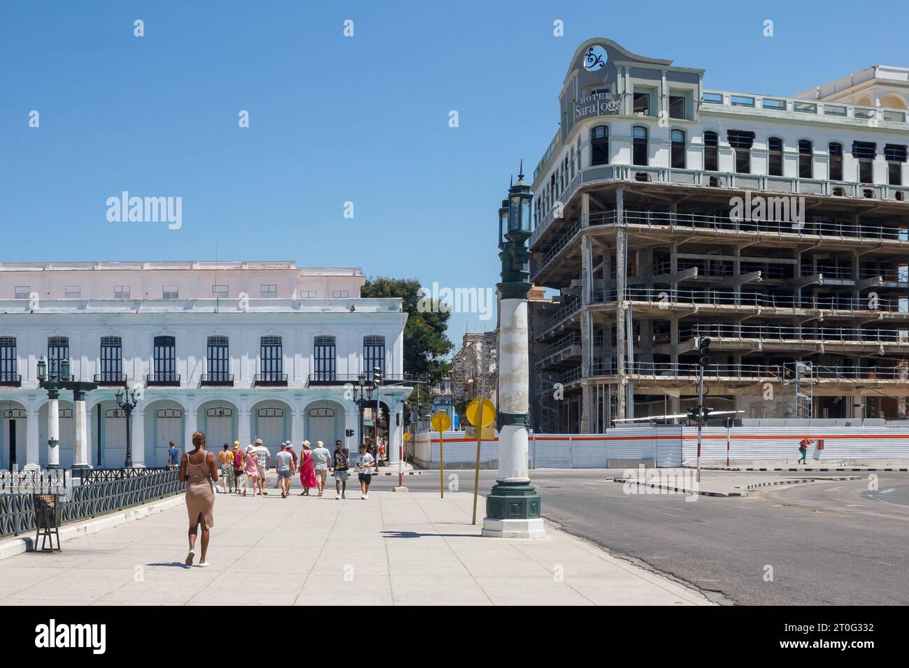 Cuban people walking in a wide sidewalk in the downtown district. The ...