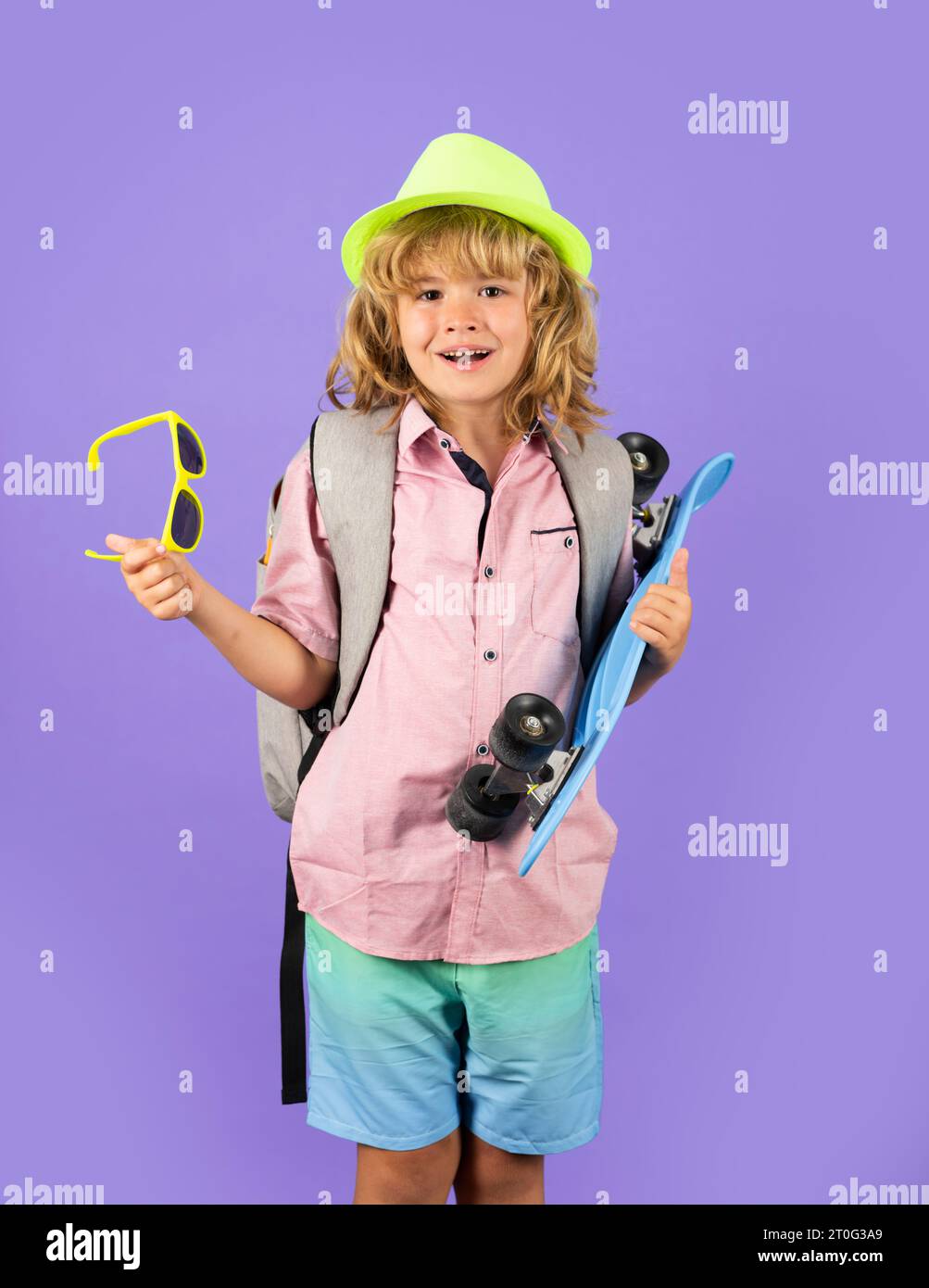 Studio portrait of stylish cute young child boy with skateboard ...