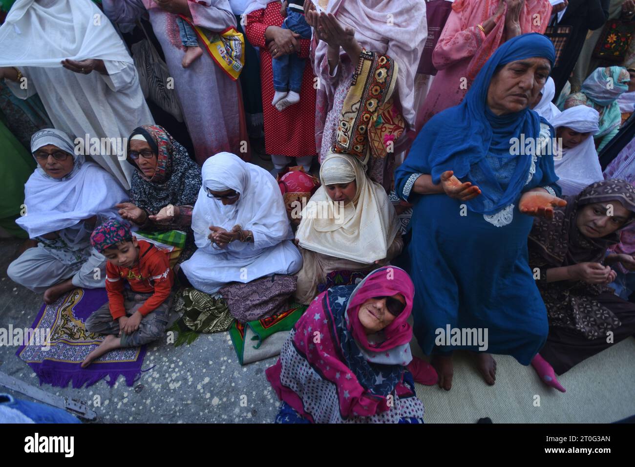 Muslims pray as the imam (not in picture) displays the holy relic of ...