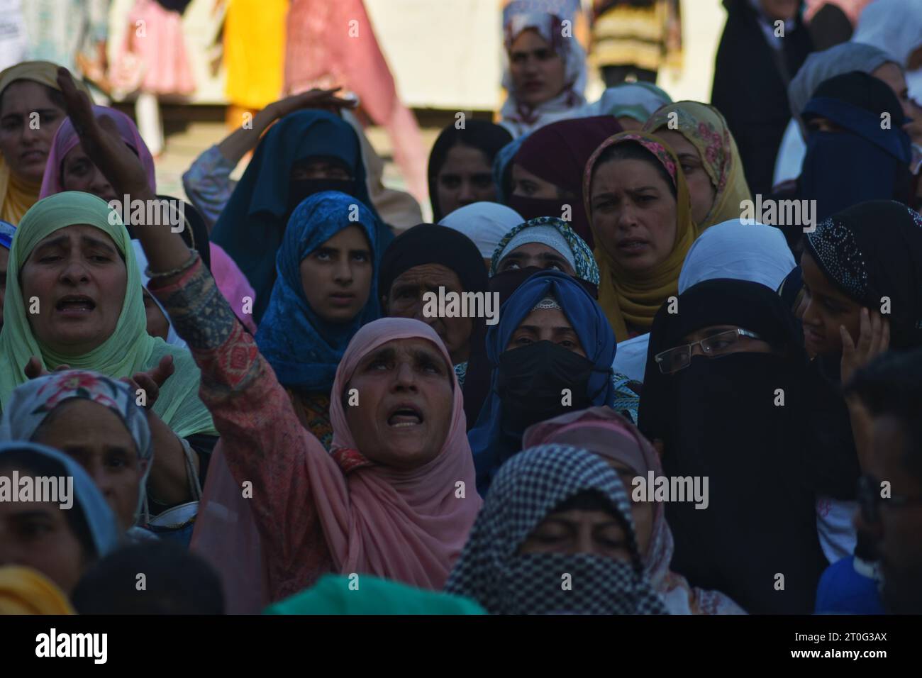 Muslims pray as the imam (not in picture) displays the holy relic of ...