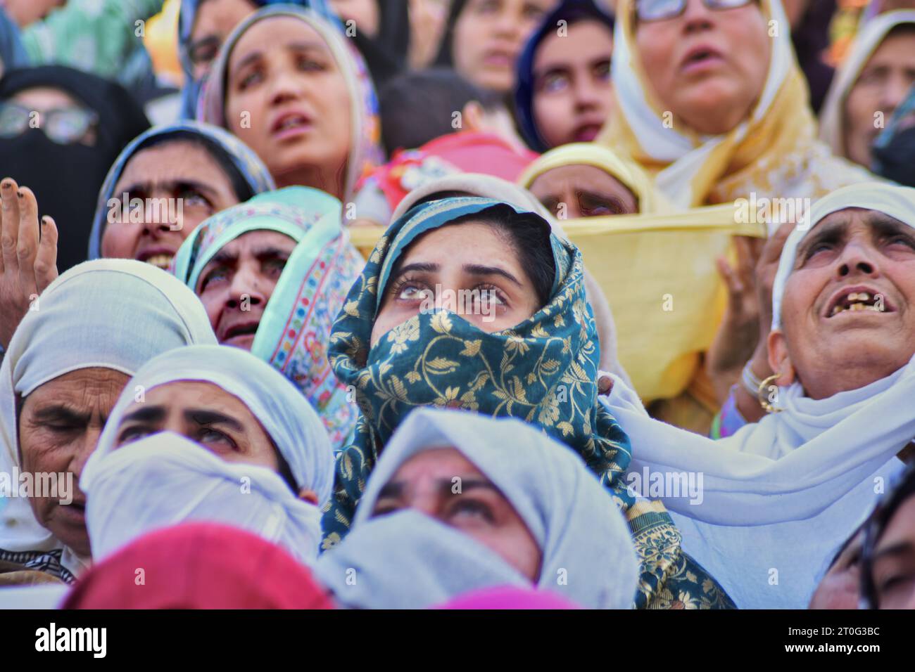Muslims pray as the imam (not in picture) displays the holy relic of ...