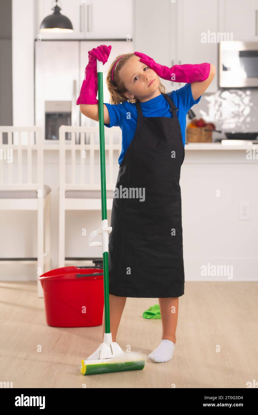 Portrait of child helping with housework, cleaning the house ...