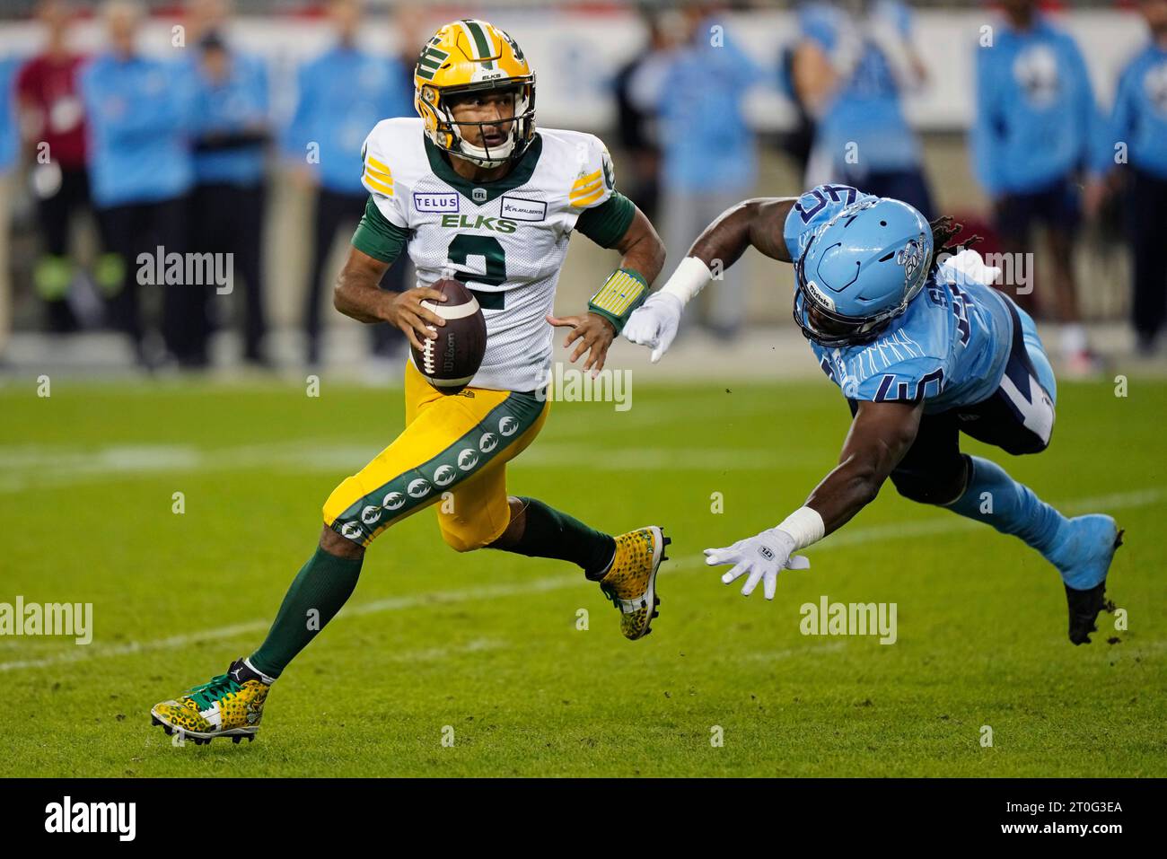 Edmonton Elks quarterback Tre Ford (2) runs away from Toronto Argonauts ...