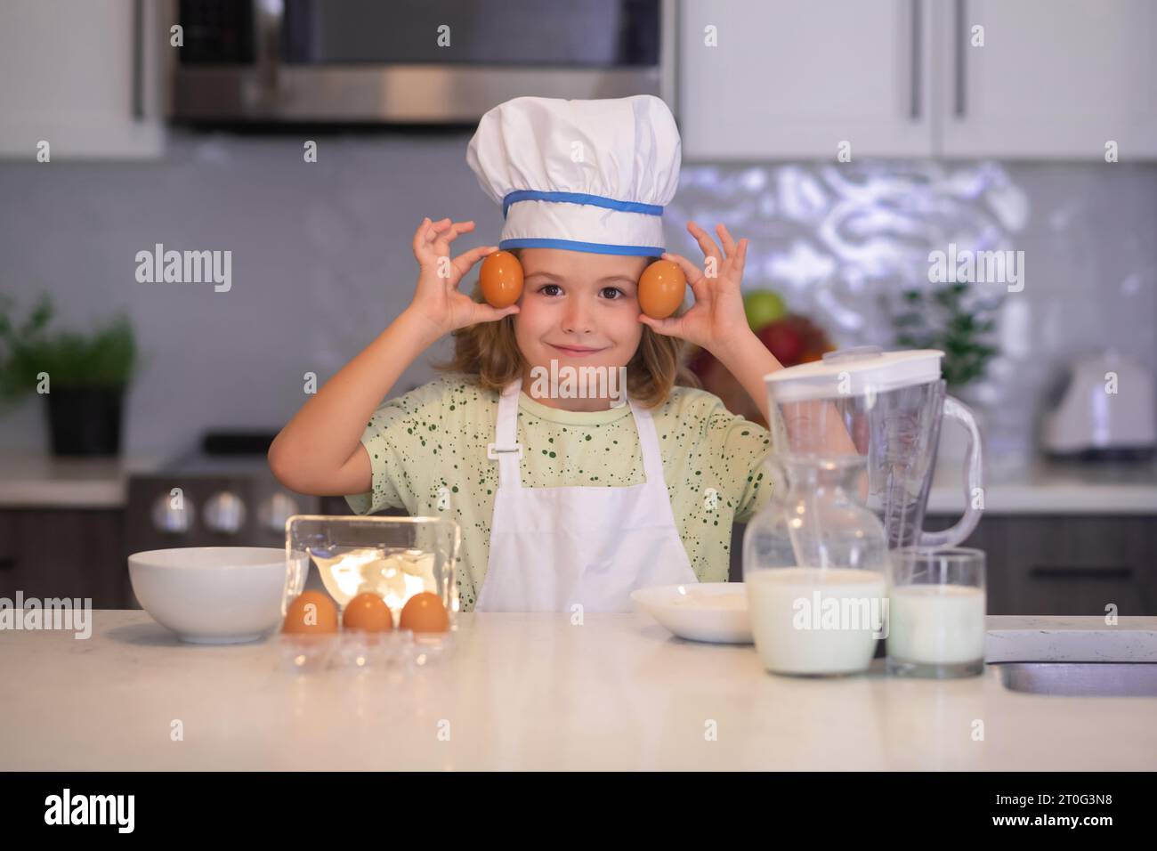 Child chef cook with eggs. Children cooking in the kitchen. Funny kid ...