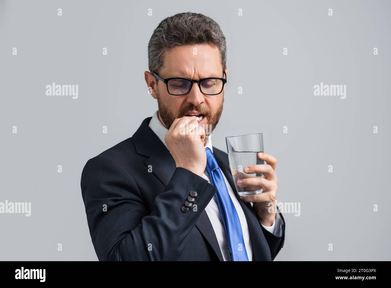 Man with headache on isolated gray studio background. Man feel pain ...