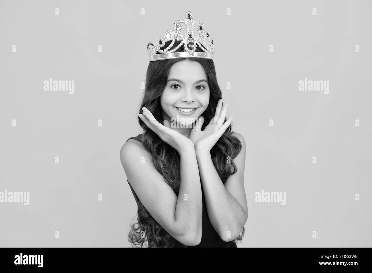Little queen wearing golden crown. Teenage girl princess holding crown ...