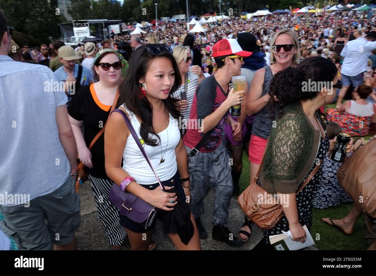 A young Asian woman heads a column of people working their way through ...