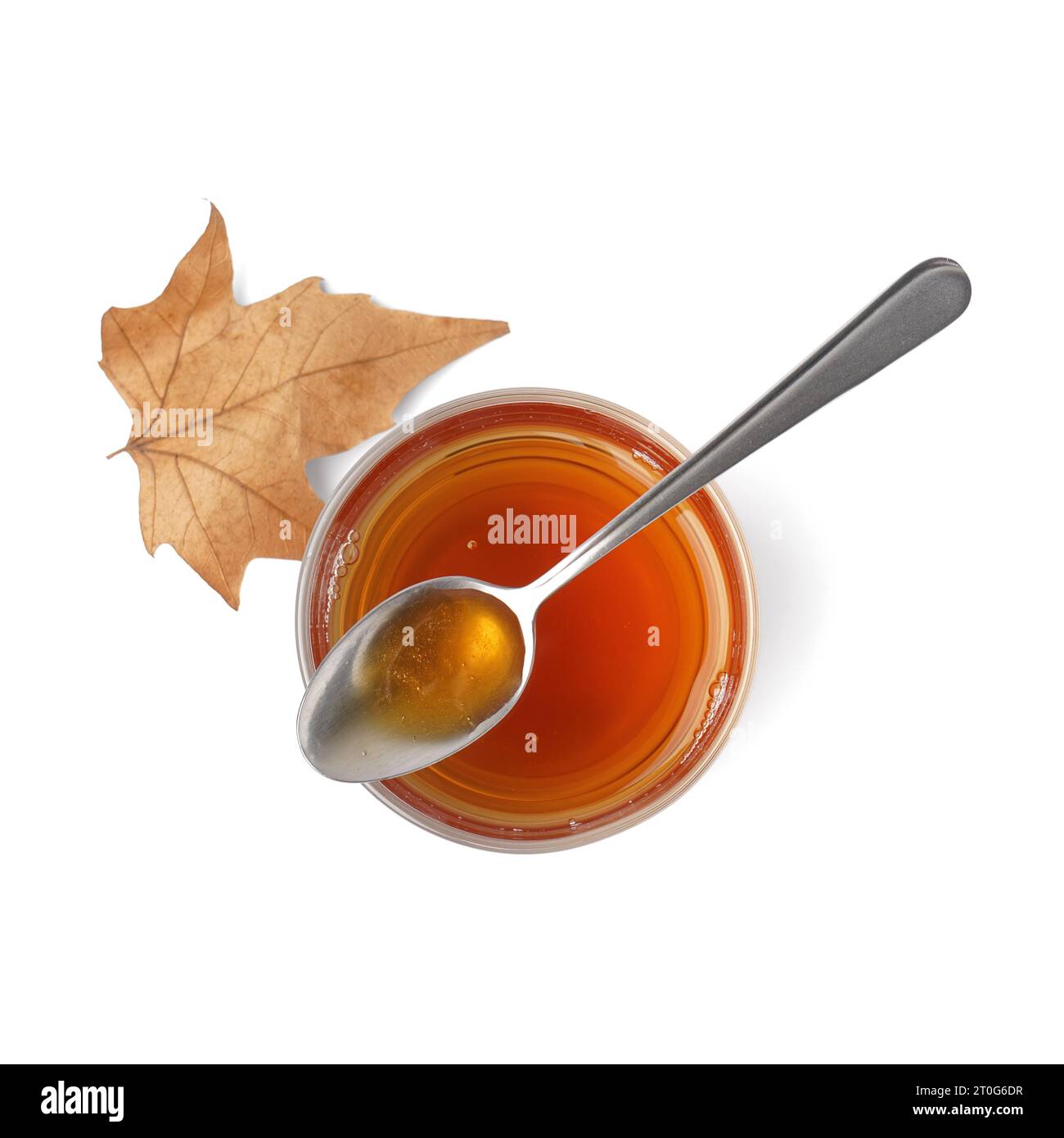 Glass and spoon of tasty maple syrup on white background Stock Photo ...
