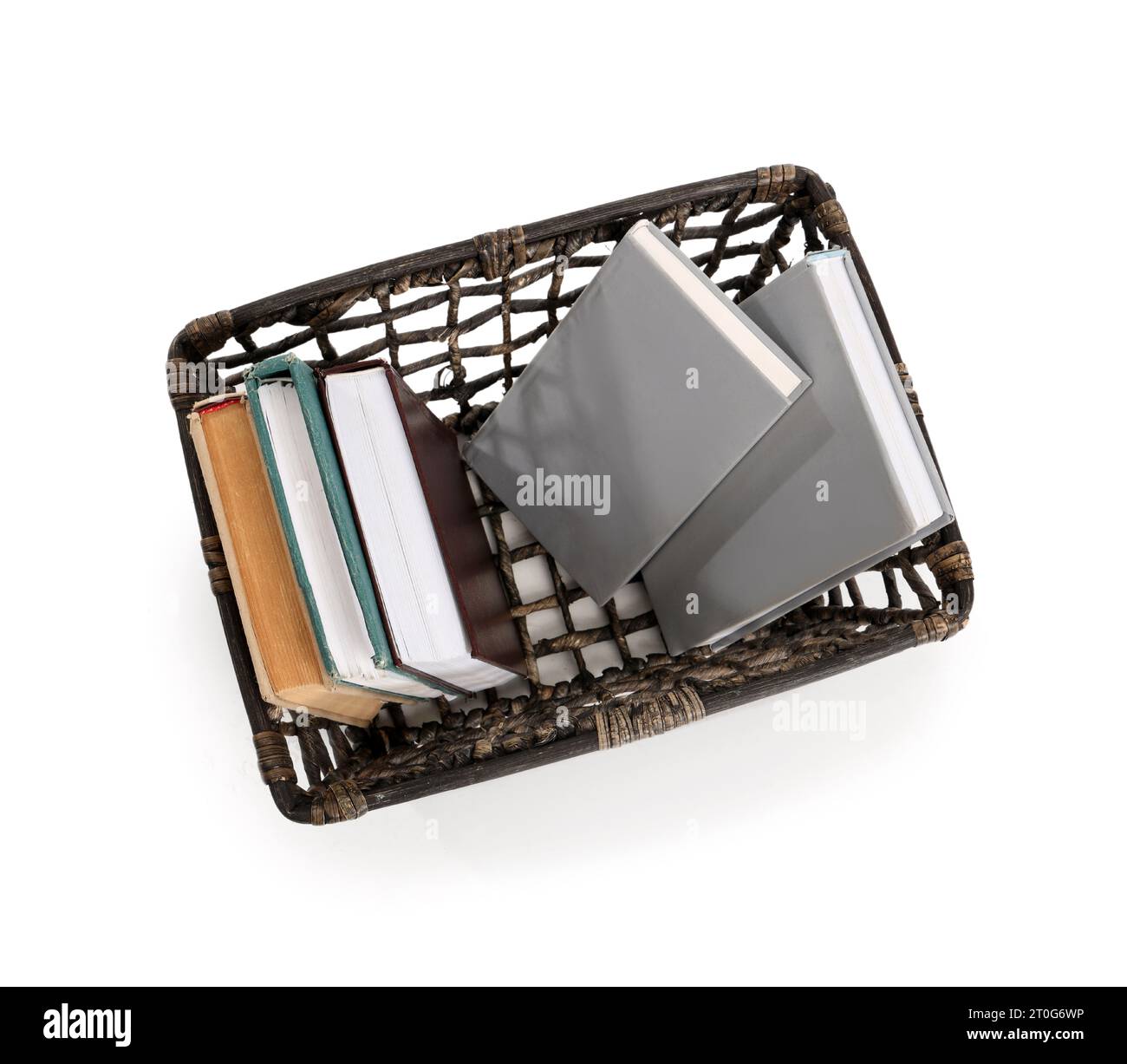 Wicker basket with books isolated on white background Stock Photo - Alamy
