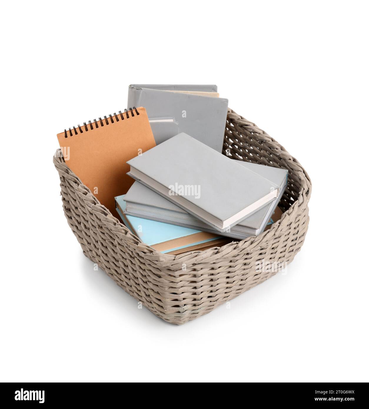 Wicker basket with books isolated on white background Stock Photo - Alamy