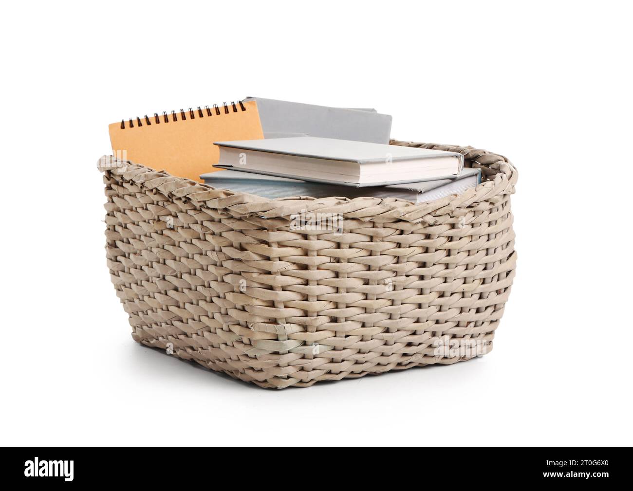 Wicker basket with books isolated on white background Stock Photo - Alamy