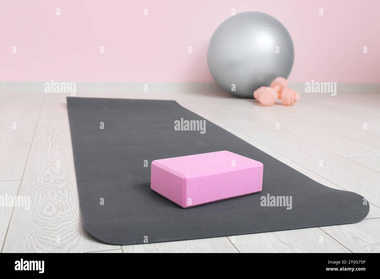 Yoga mats with foam exercise block in interior of gym Stock Photo - Alamy