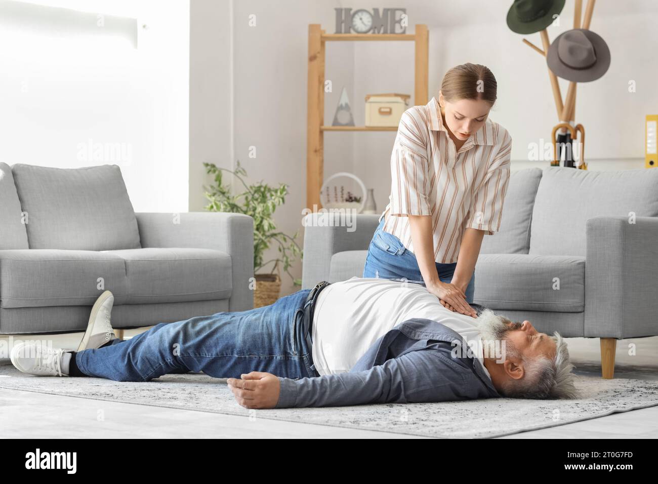 Woman doing CPR on her unconscious father at home Stock Photo - Alamy