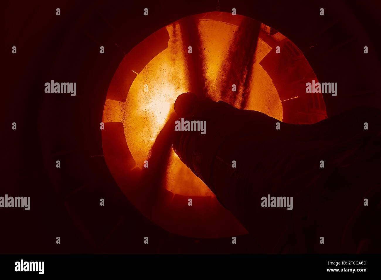 Pouring lime into working area of rotating burning kiln Stock Photo - Alamy