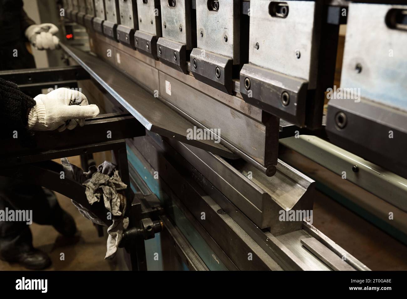 Bending press operates with metal sheet in plant workshop Stock Photo ...