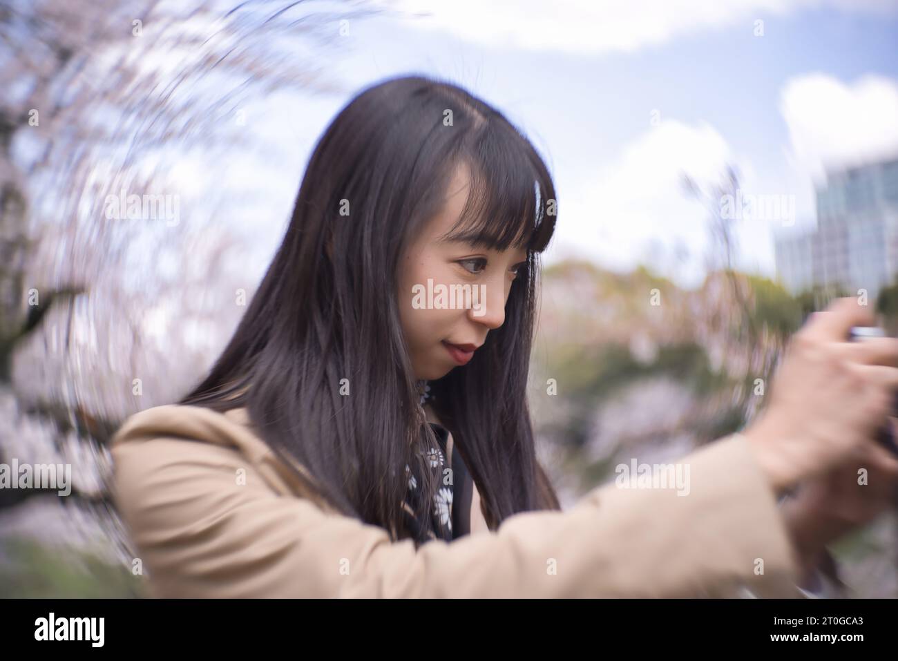 A portrait of Japanese woman shooting by mirrorless camera behind ...