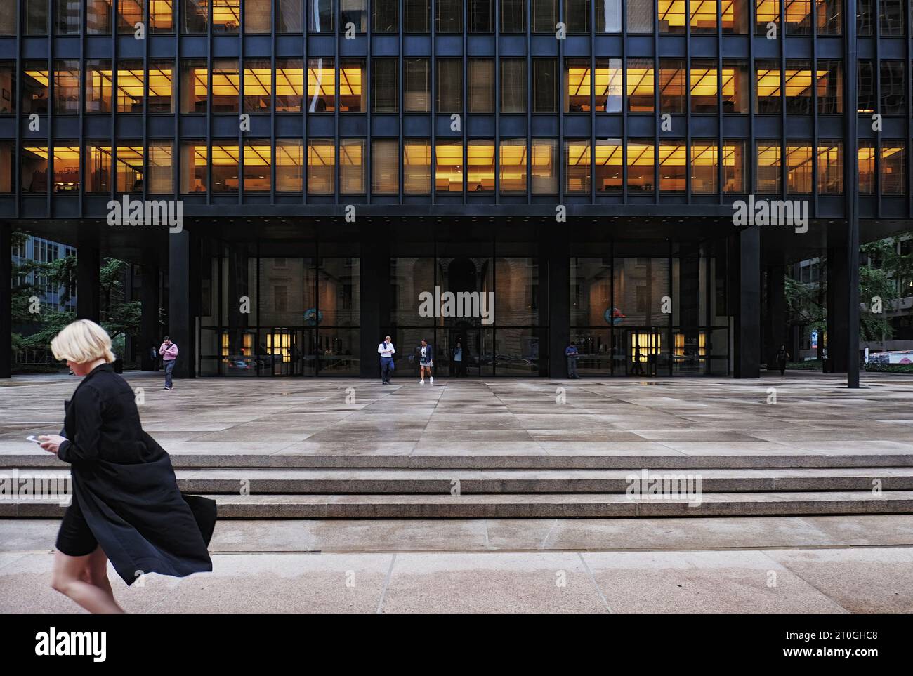 A woman walks pastt the iconic Seagram building, by architect Ludwig ...