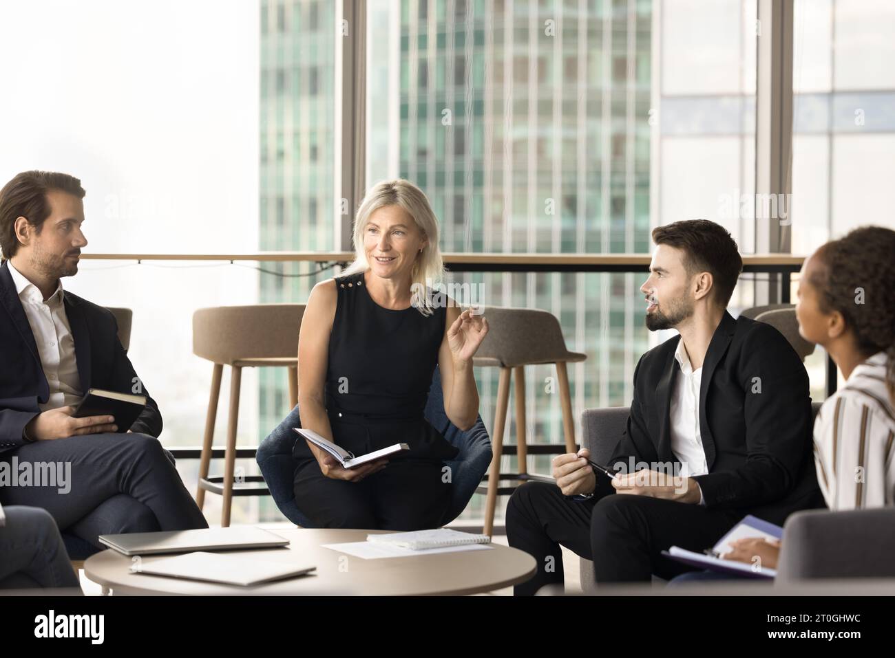 Pretty mature business coach training office staff, giving lecture ...