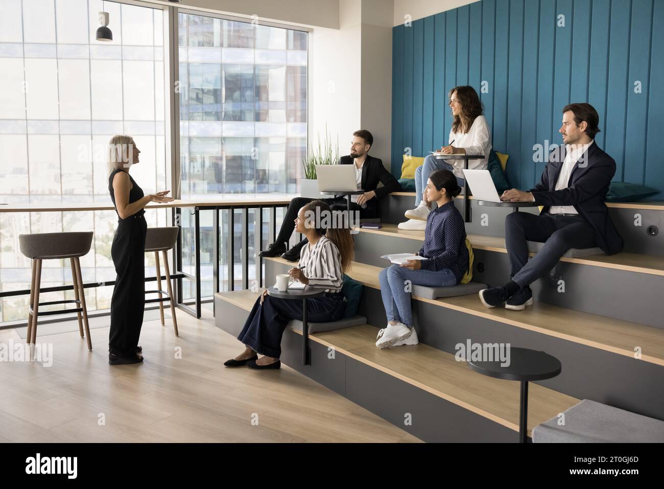 Mature speaker talking to office audience, giving professional seminar ...