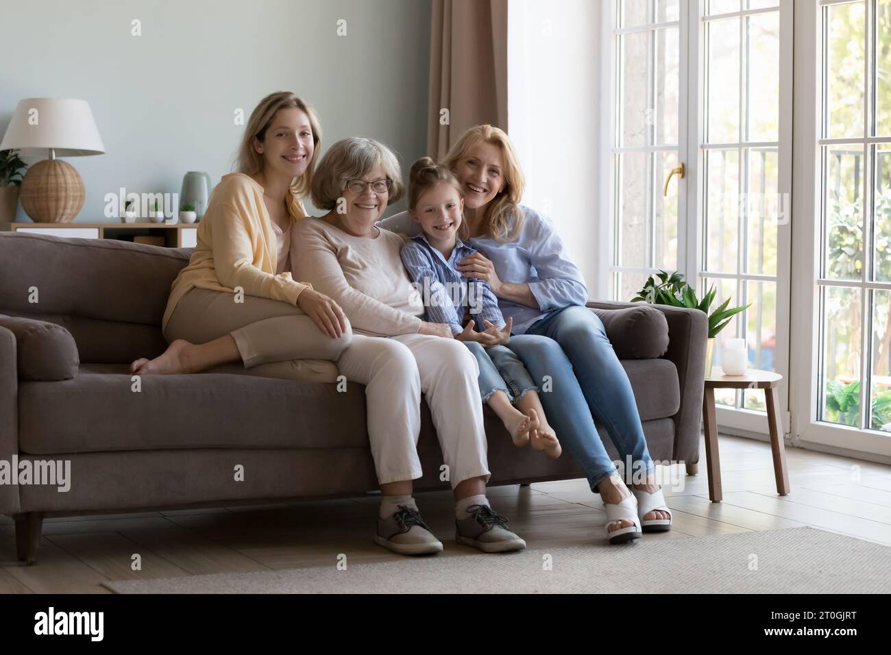 Happy girls and women of four different generations resting close Stock ...