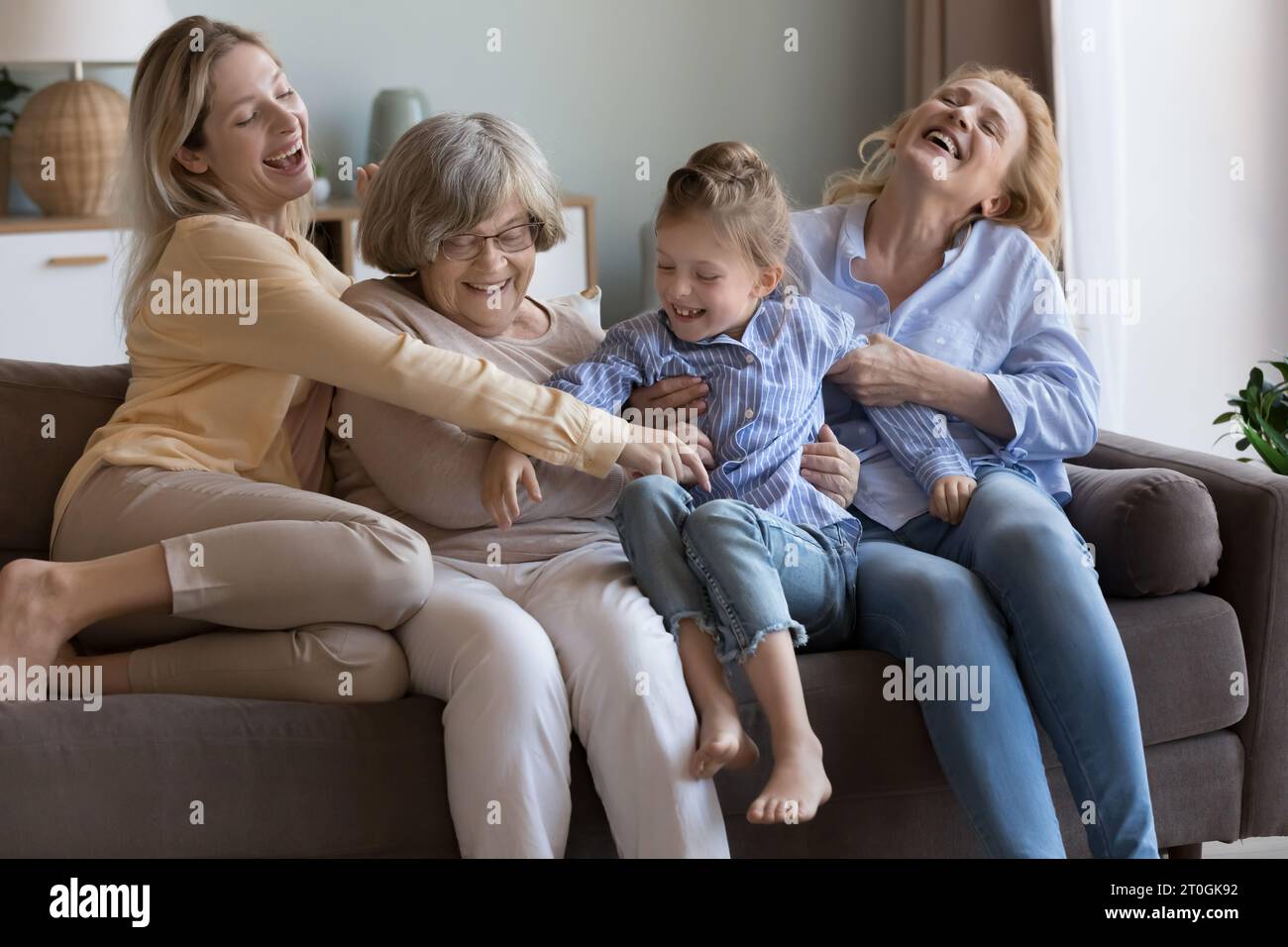 Joyful girls and women of four female generations having fun Stock ...