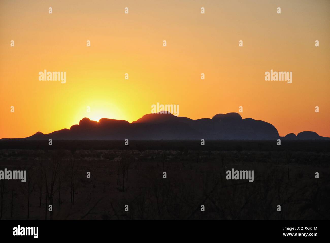 The Olgas sun set between round rocky bulges of Kata Tjuta landscape ...