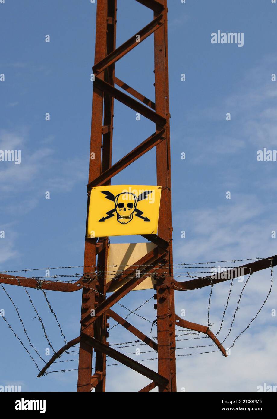 High voltage wire pylon with skull and lightning symbol indicating ...