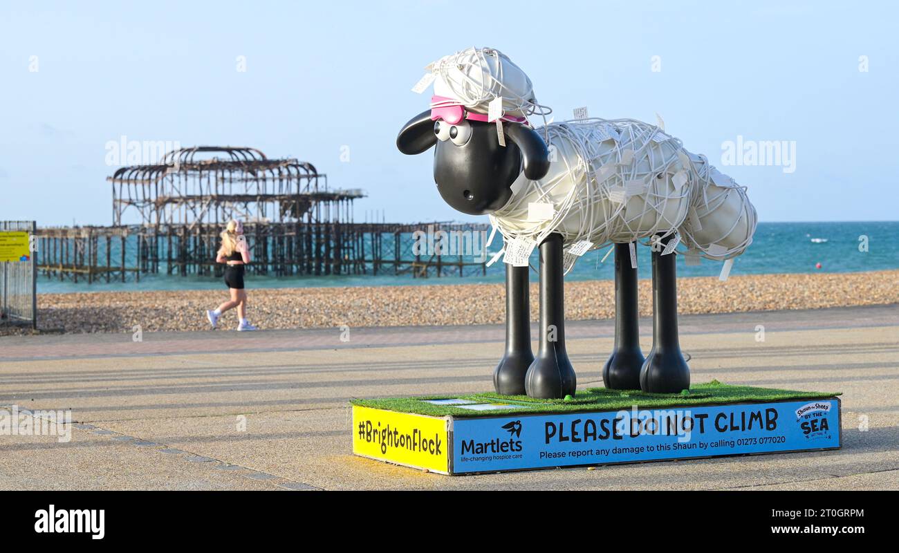 Brighton UK 7th October 2023 - A runner passes by a Shaun the Sheep ...
