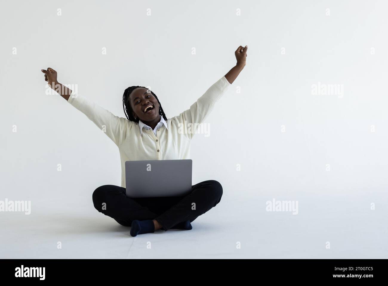 Happy woman with a laptop computer and arms up - isolated over white ...