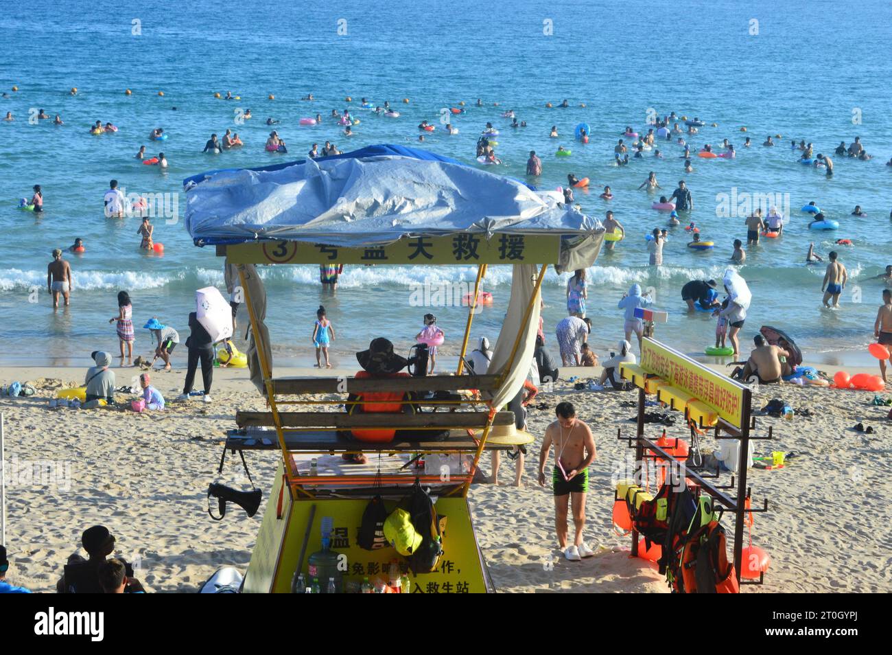 Tourists play at the seaside during the National Day holiday in Sanya ...