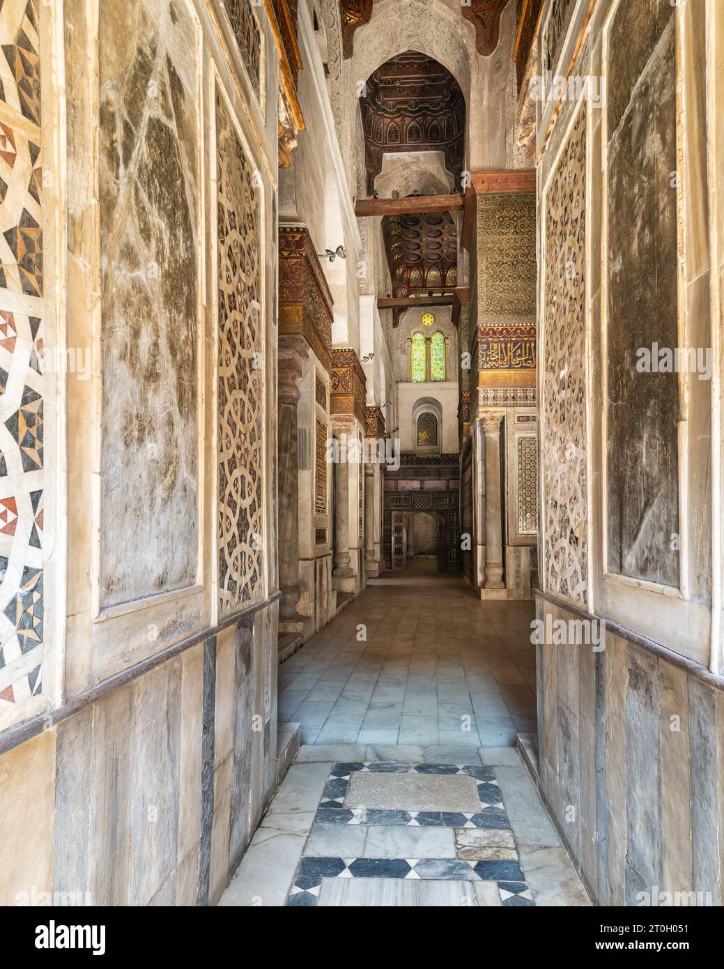 Narrow hallway with decorated marble walls in the Qalawun Complex, a ...