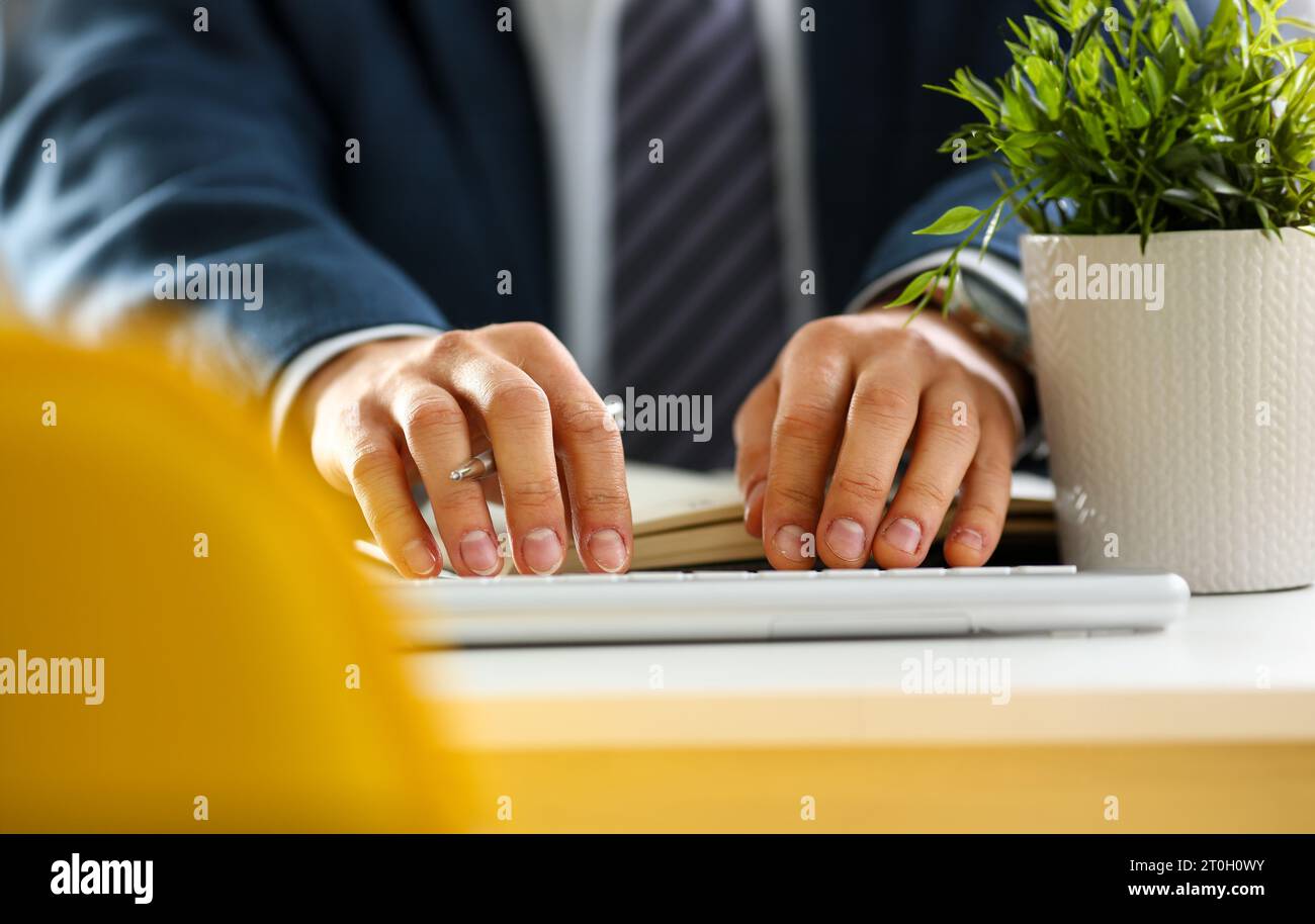 Male arms in suit typing on silver keyboard Stock Photo - Alamy