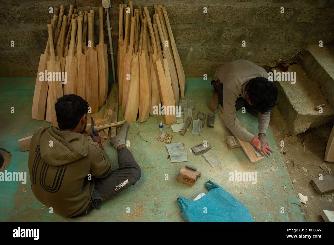 Kashmir, India. 2nd Oct, 2023. Workers finish working on Kashmiri willow wood cricket bats at a ...