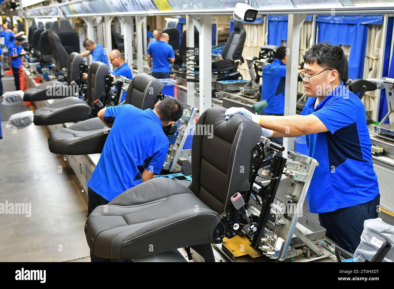 YANTAI, CHINA - OCTOBER 7, 2023 - Workers assemble car seats on a ...