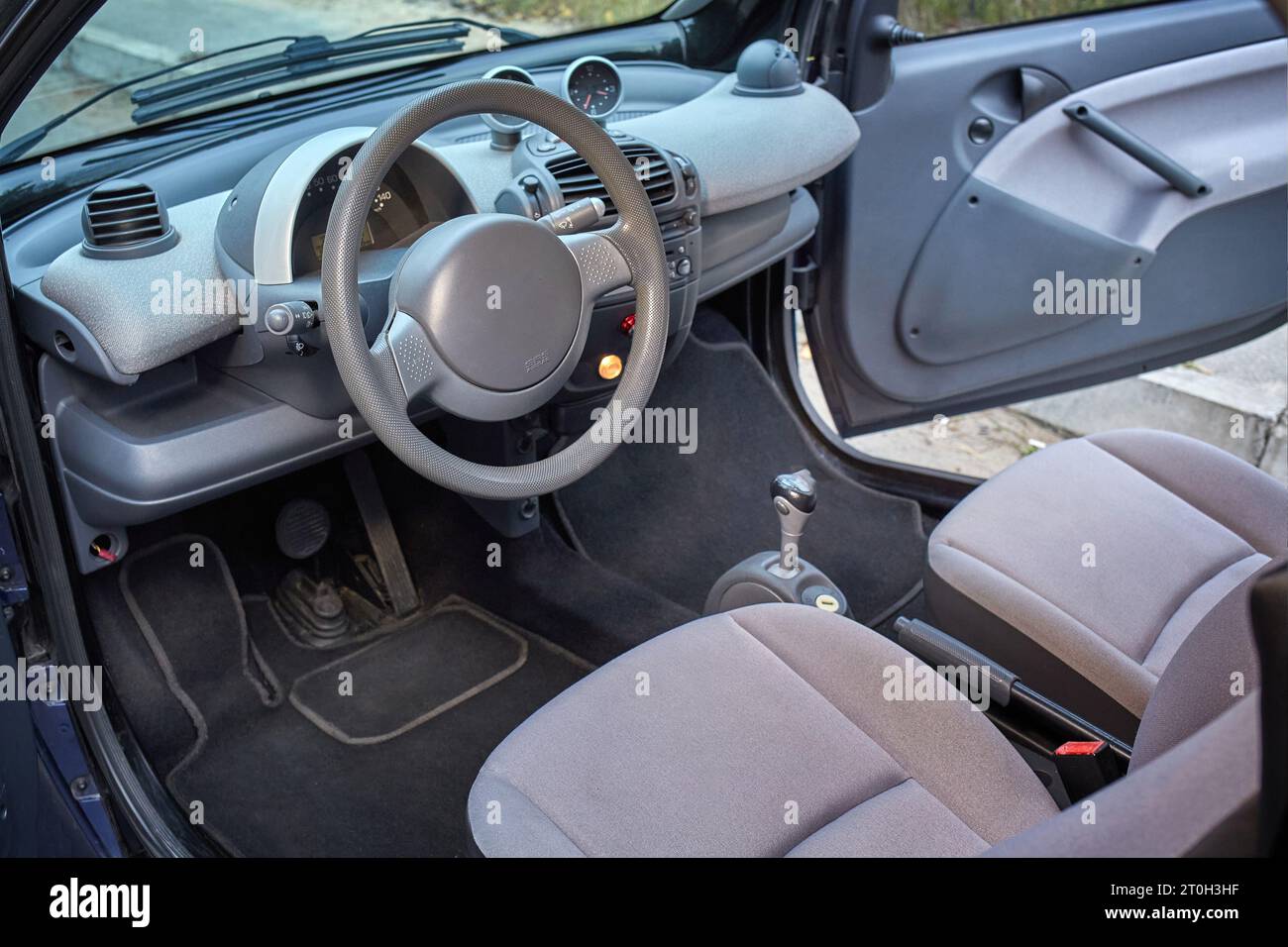 Shift lever, car steering wheel and sensors. Inside a modern car view ...