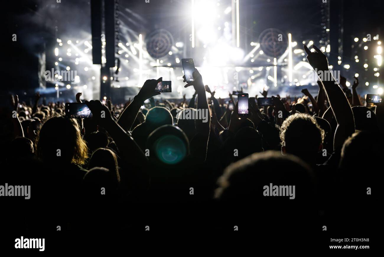 The crowd on the dance floor during the music show, happy people with ...