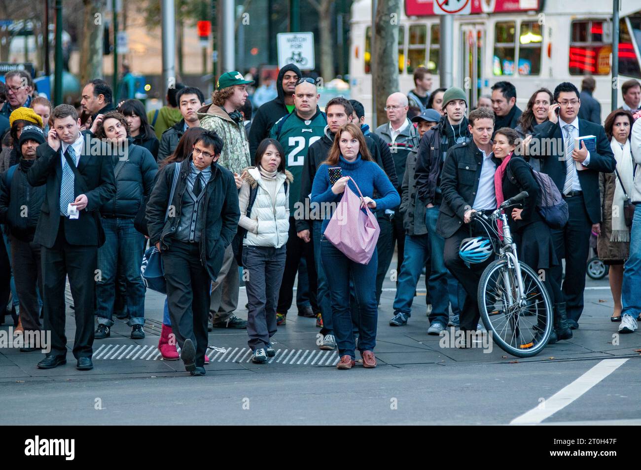 Homeward-bound commuters at the pedestrian crossing outside Flinders ...
