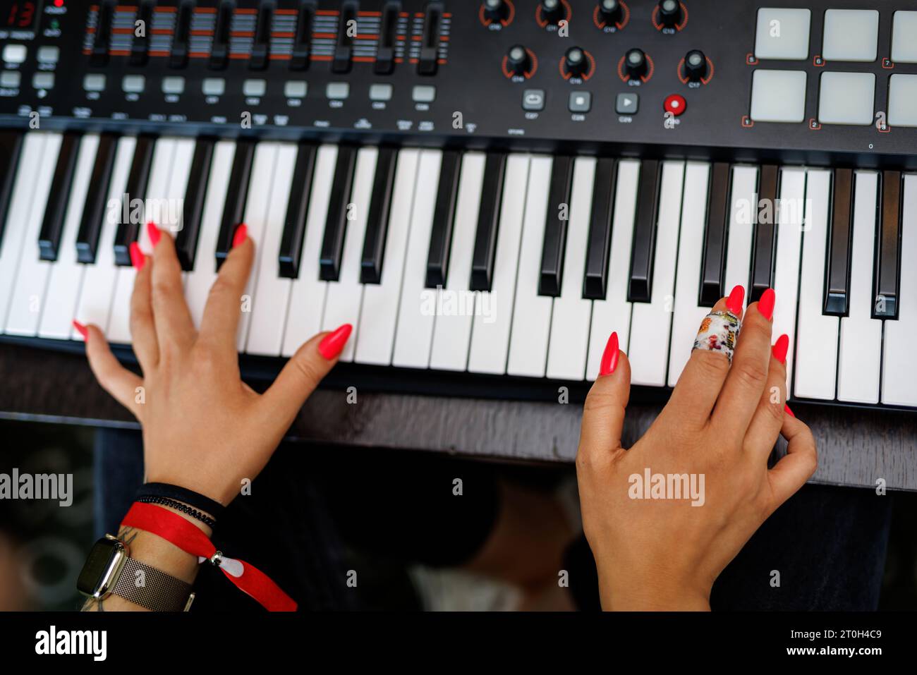 Top view of Red Nails Hands of a Pianist or Keyboardist from a Rock ...