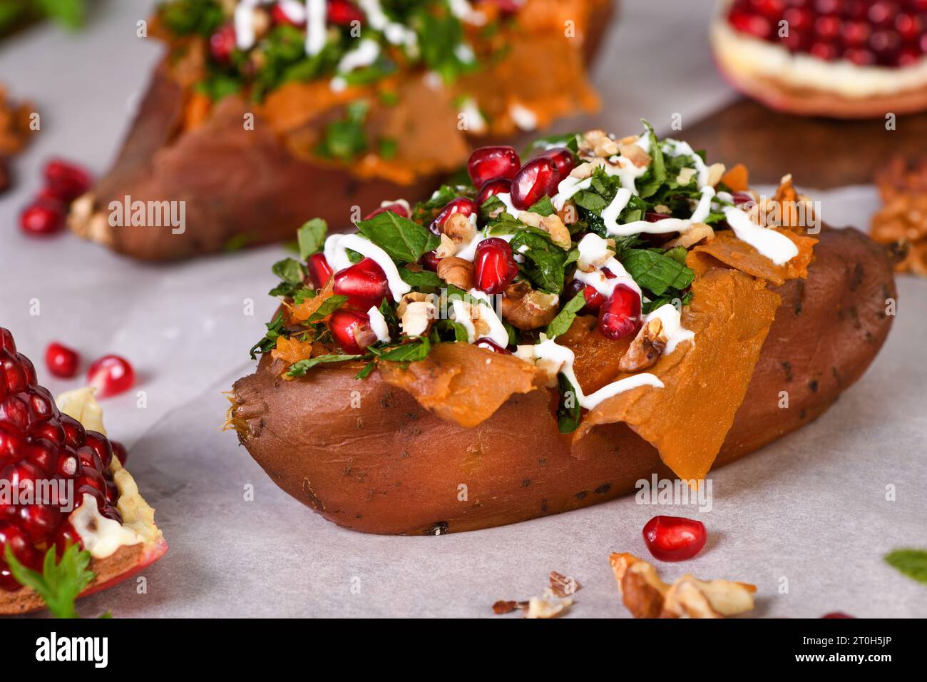 Baked stuffed sweet potatoes filled with walnuts, fresh herbs, mint and ...