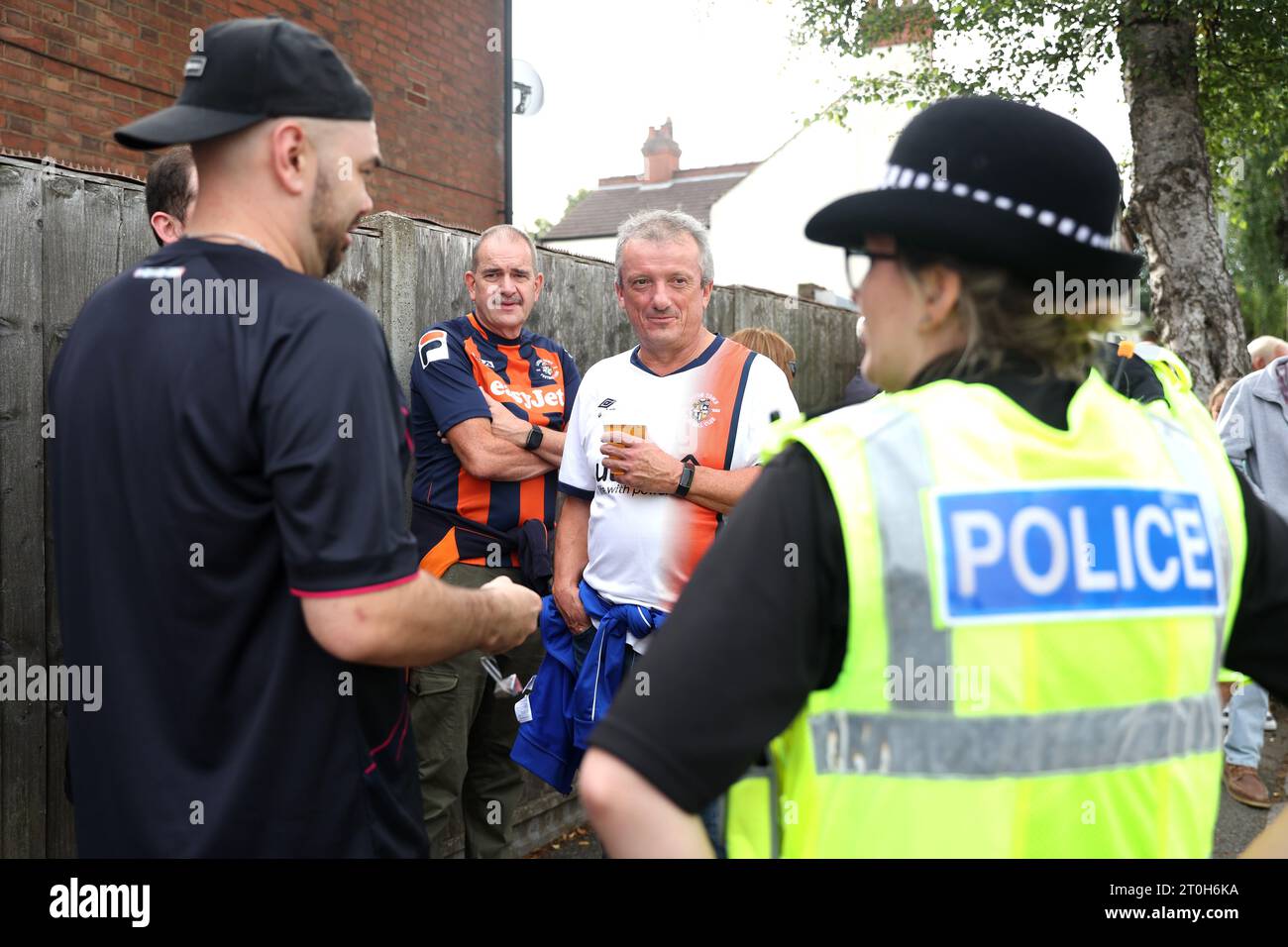 Luton Town fans speak with police officers before the Premier League ...