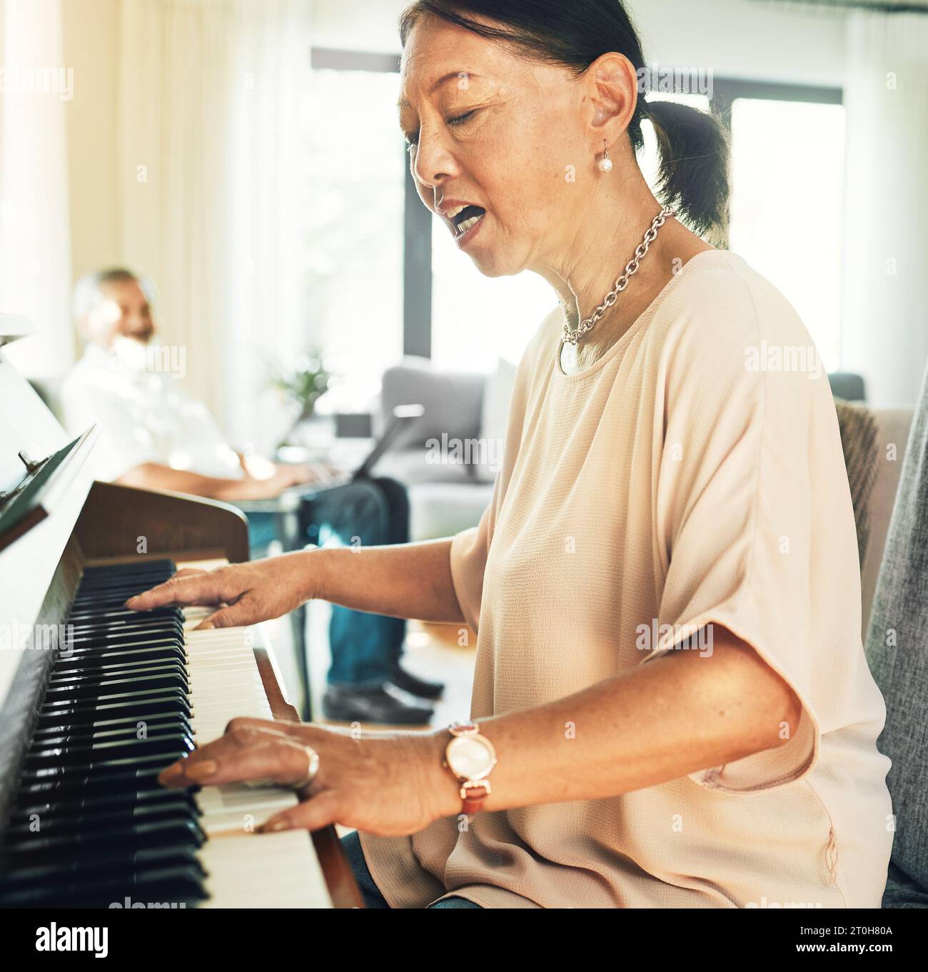 Singing, piano and senior woman playing for music with husband in ...
