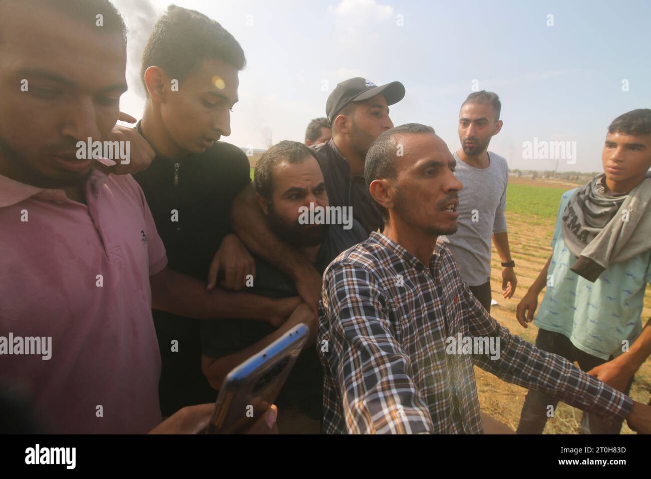 Palestinians transport a captured Israeli civilian, center, from Kfar ...