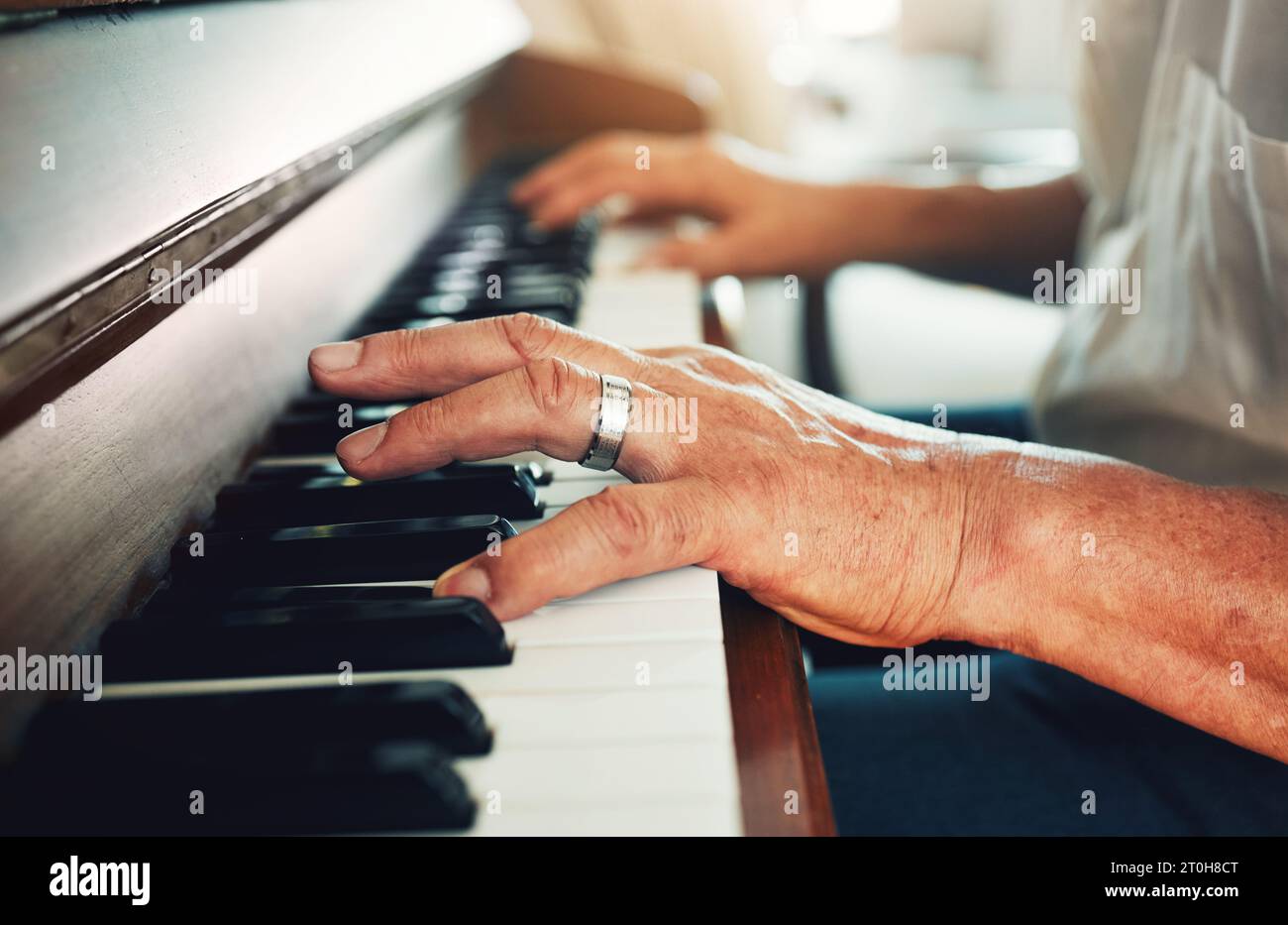 Hands, piano and senior man playing for music in living room for ...