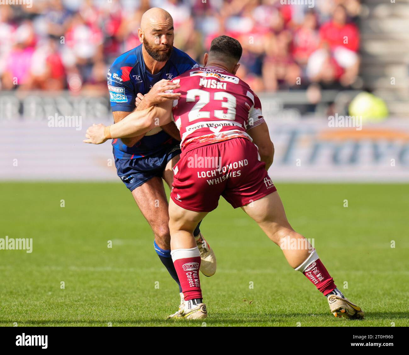 Kane Linnett #12 of Hull KR runs at Abbas Miski #23 of Wigan Warriors ...