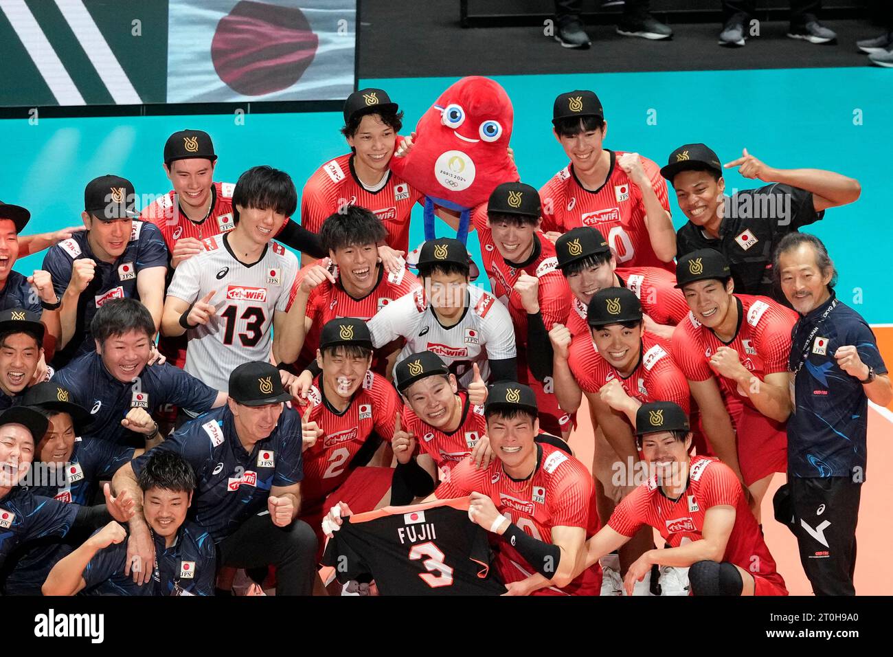 Japanese men's volleyball team and team staff pose for a photo as the ...