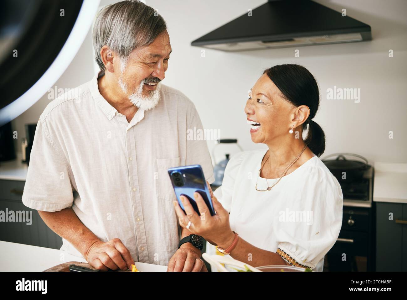 Home, influencer and senior couple with a smartphone, social media and ...