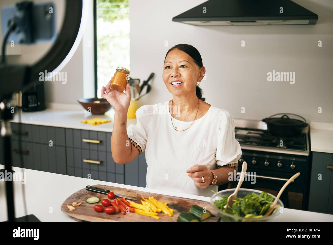 Asian woman, happy and live streaming for cooking with bottle, healthy ...