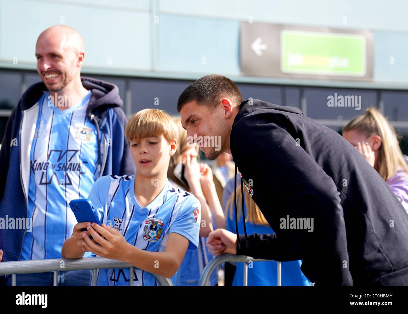 Coventry City's Bobby Thomas poses for a photo with a fan ahead of the Sky Bet Championship ...
