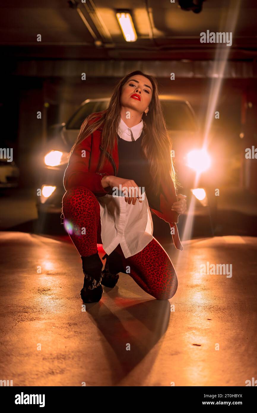 Young woman crouching car portrait hi-res stock photography and images ...